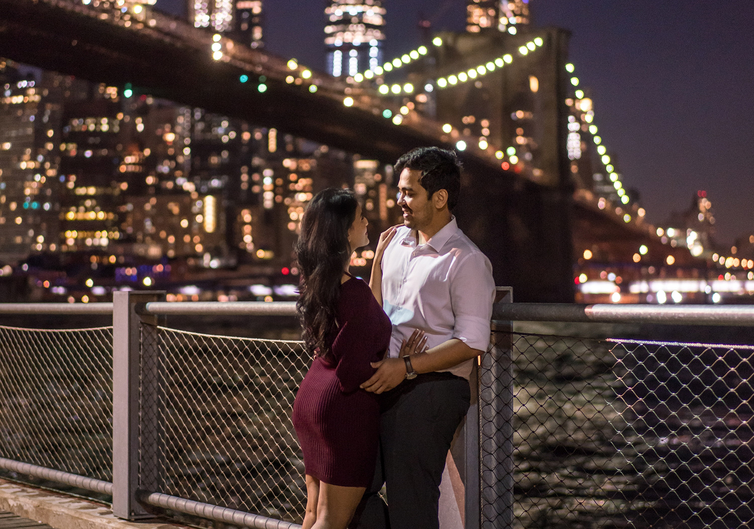 A proposal overlooking a glittering skyline and the setting sun ...